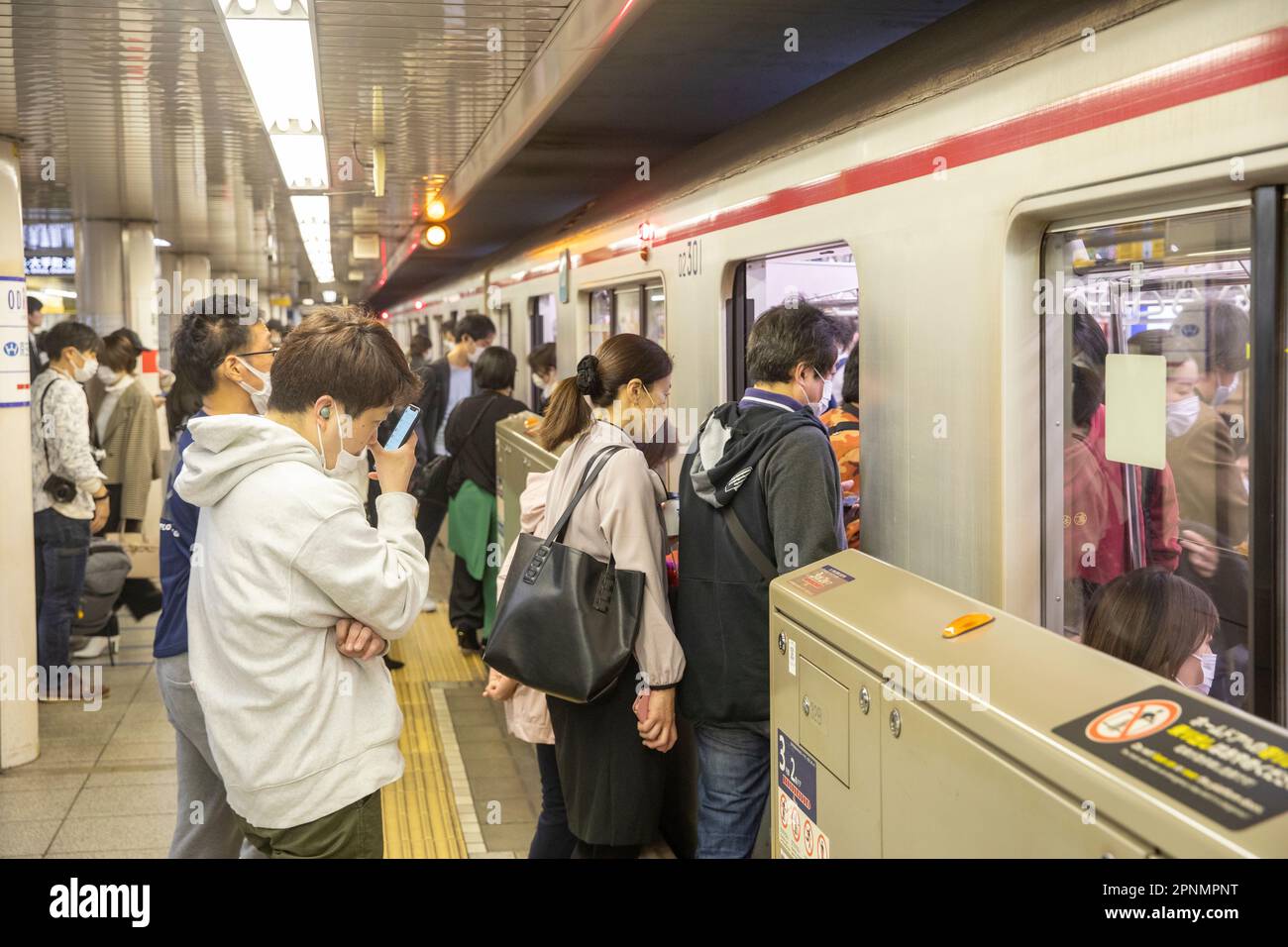 Tokyo rail network April 2023, Japanese commuters board a train railway ...