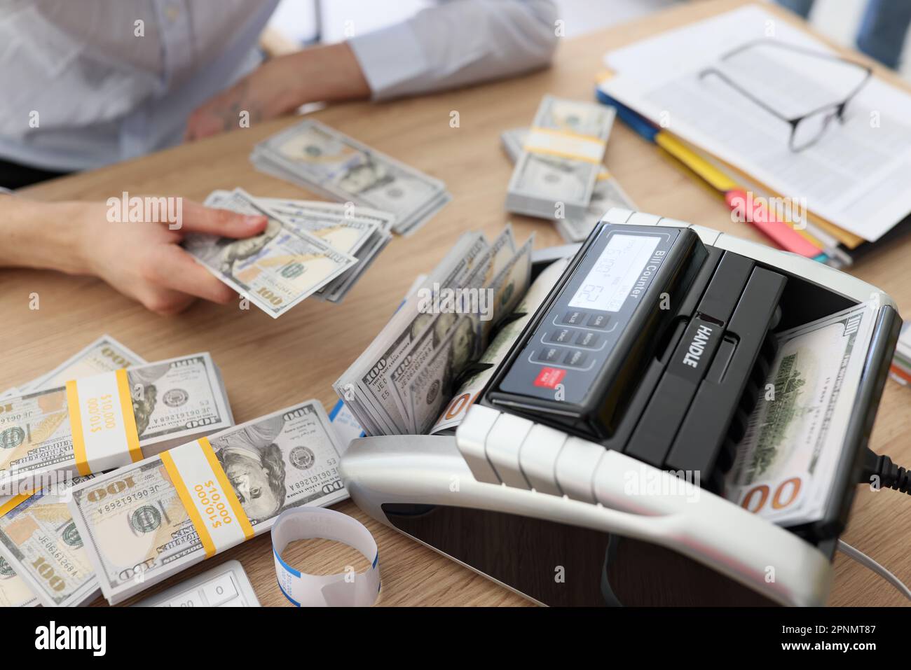 Woman uses bill counter to count money after profitable deal Stock ...