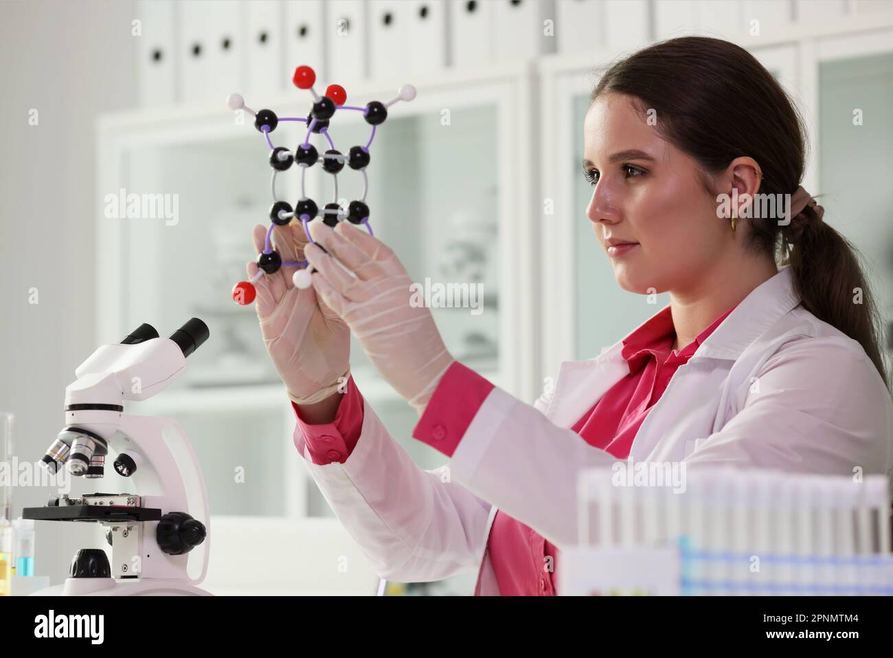 Woman scientist examines molecular structure hi-res stock photography ...