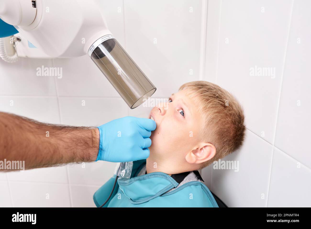 Radiographer taking teeth radiography to a boy using digital x-ray ...