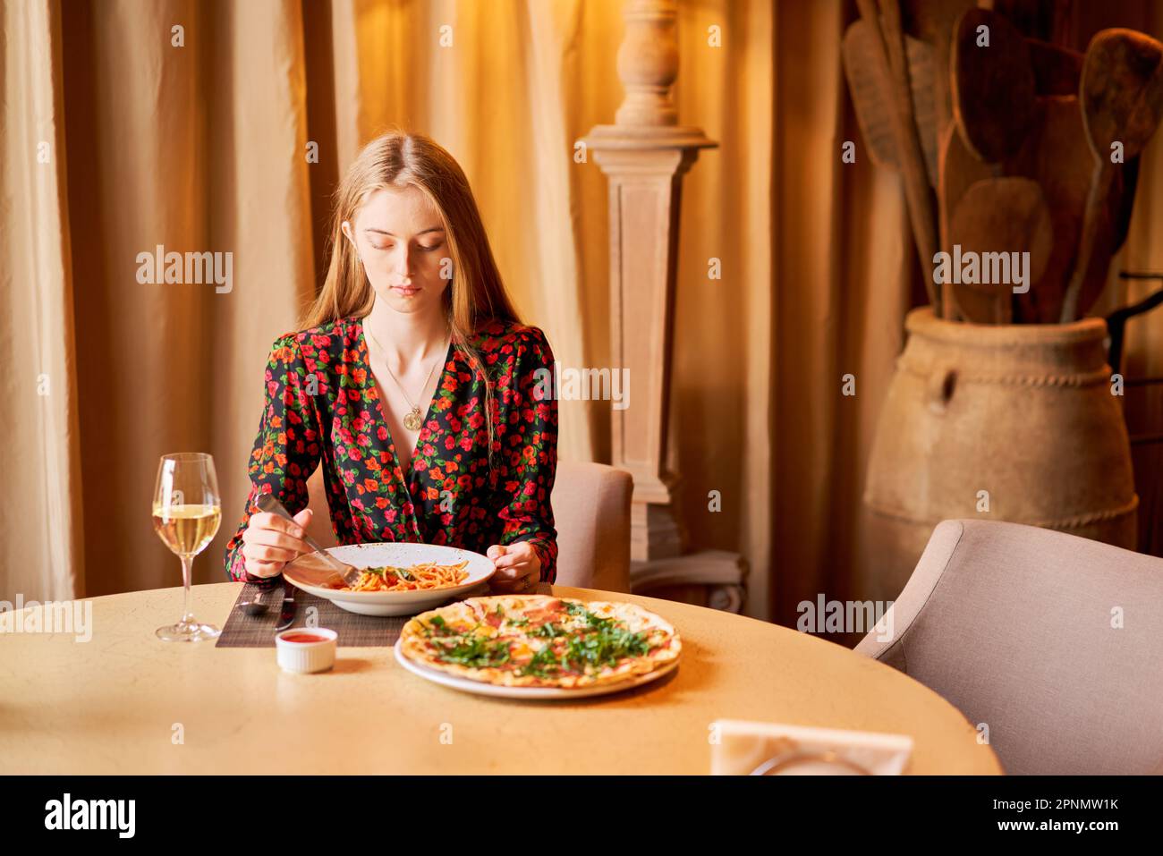 Italian Trattoria. Woman eats Italian pasta with tomato, meat ...
