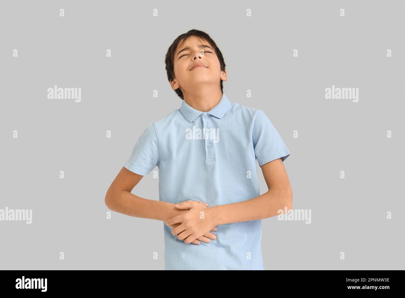 Little boy with appendicitis on grey background Stock Photo - Alamy