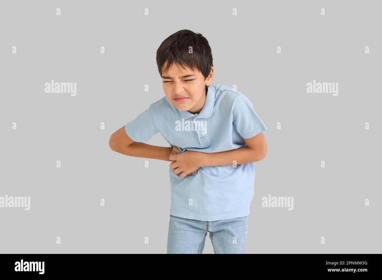 Little boy with appendicitis on grey background Stock Photo - Alamy