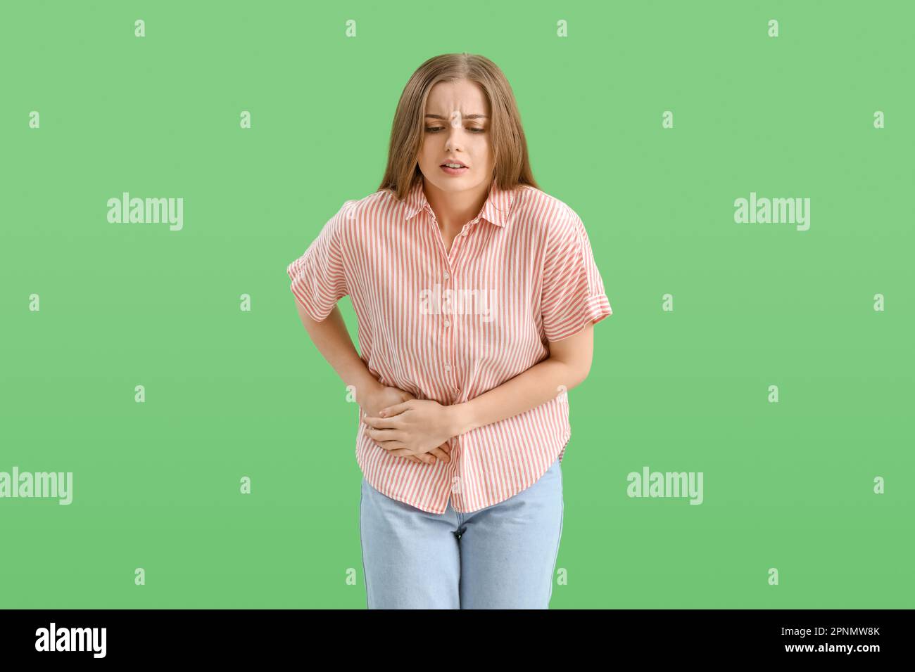 Young woman with appendicitis on green background Stock Photo - Alamy
