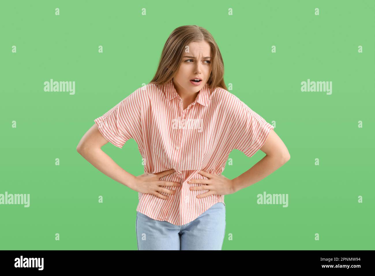 Young woman with appendicitis on green background Stock Photo - Alamy