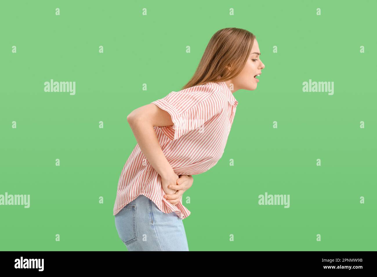 Young woman with appendicitis on green background Stock Photo - Alamy