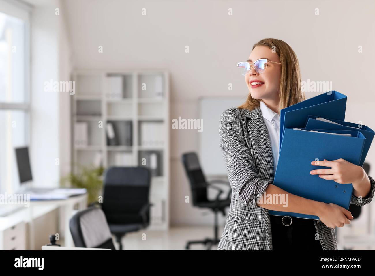 Female accountant with folders in office Stock Photo - Alamy