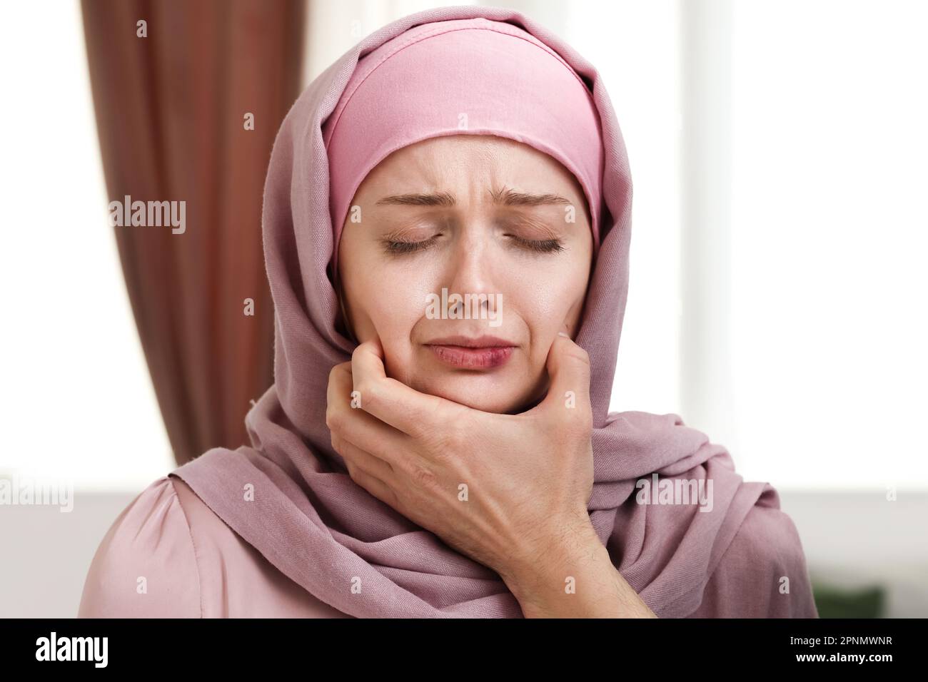 Muslim man holding bruised woman by face at home, closeup. Domestic violence concept Stock Photo ...