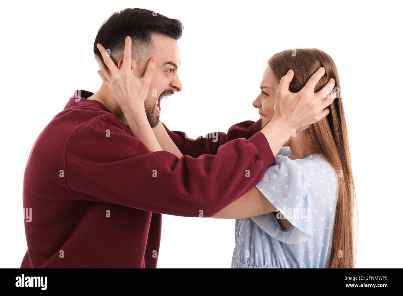 Angry young couple shouting on white background. Domestic violence ...