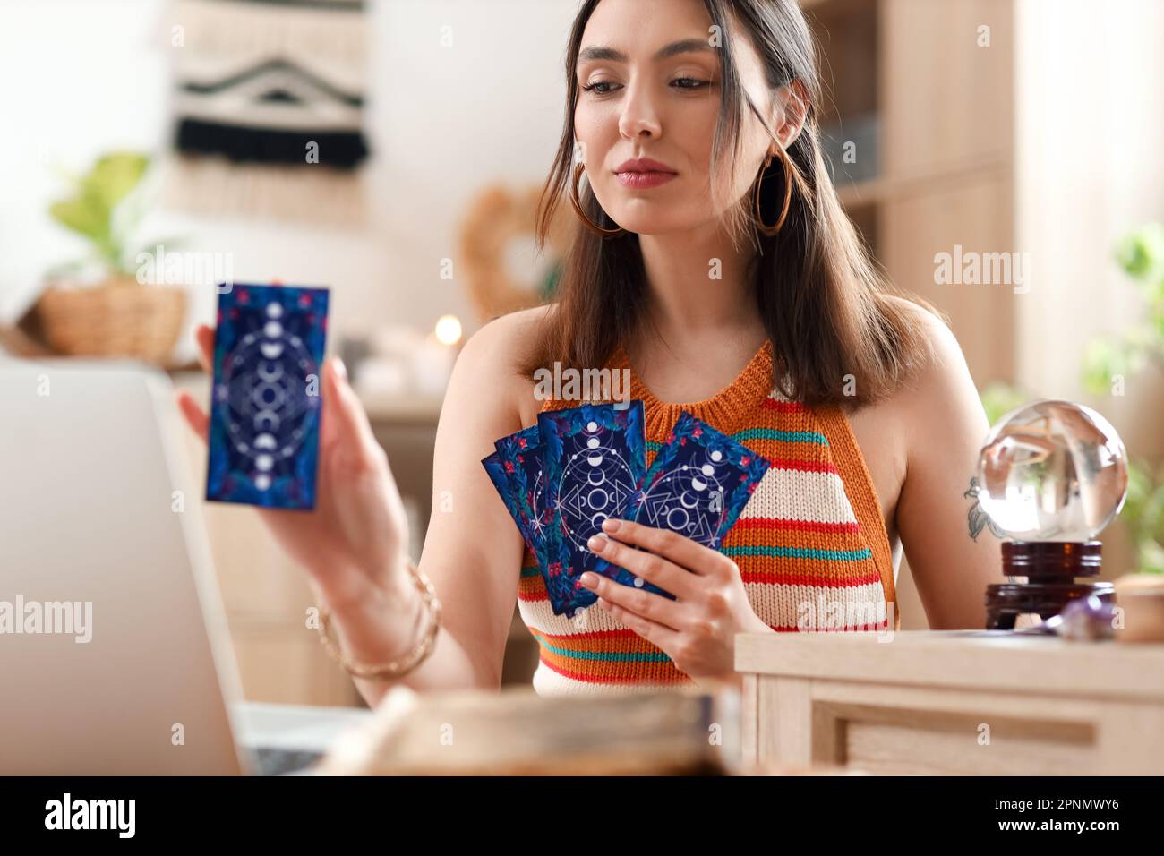 Young fortune teller with tarot cards recording video at home Stock ...
