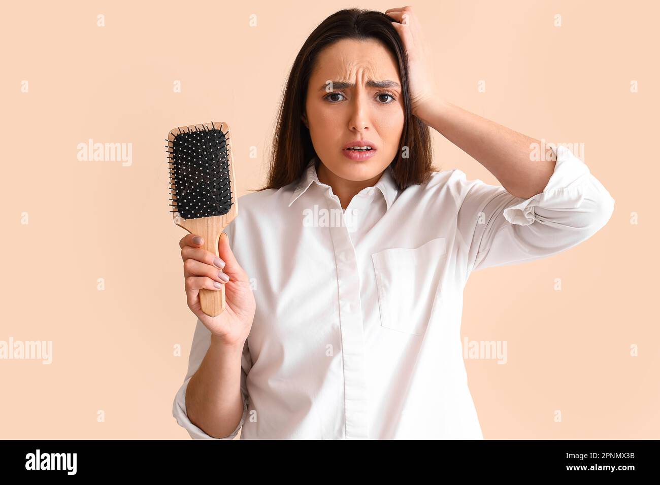 worried young woman with hair loss problem on beige background Stock ...