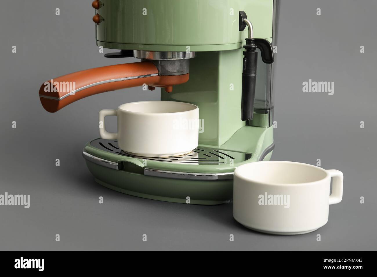 Modern coffee machine with cups on grey background Stock Photo - Alamy