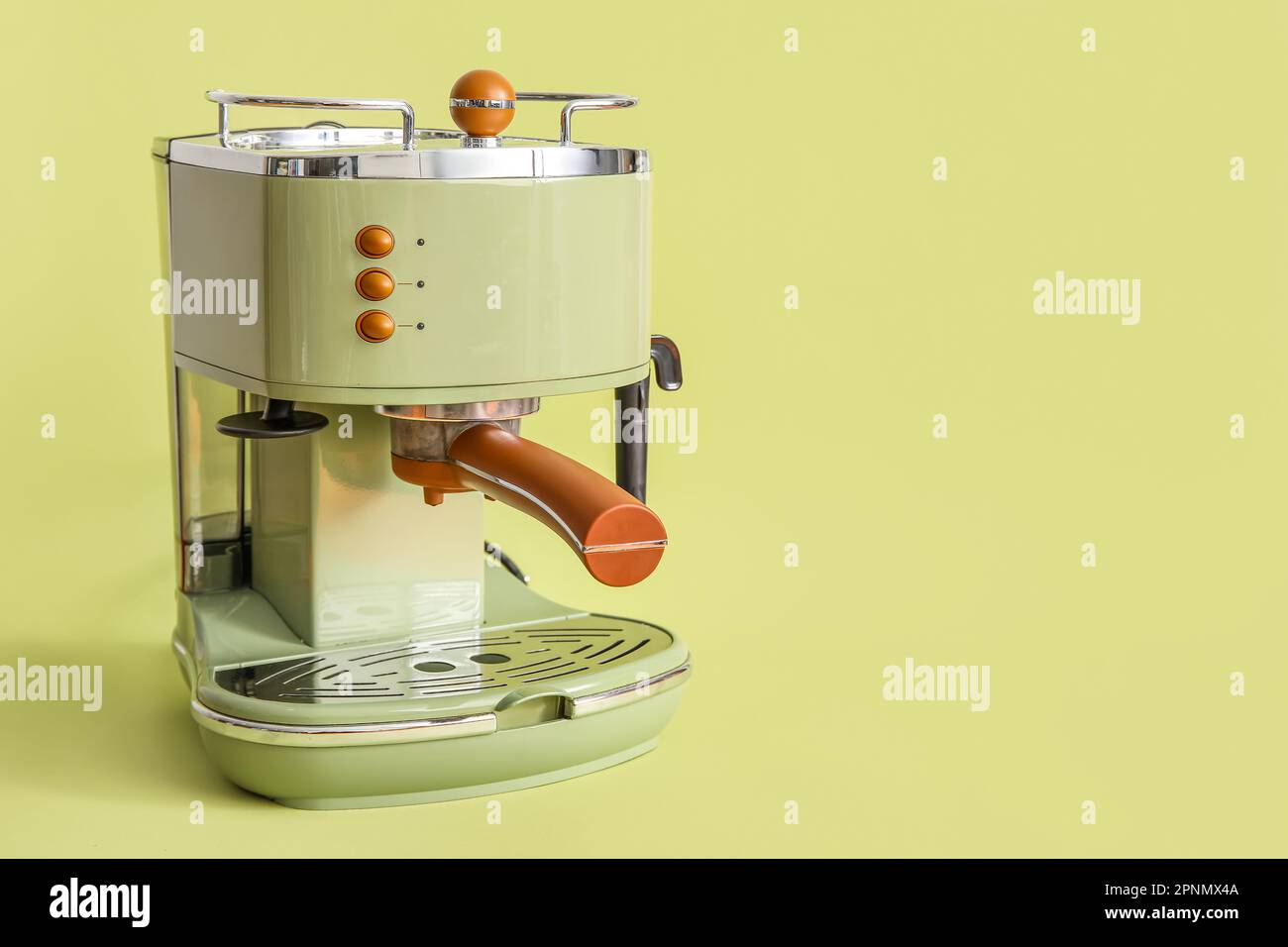 Modern coffee machine on green background Stock Photo - Alamy