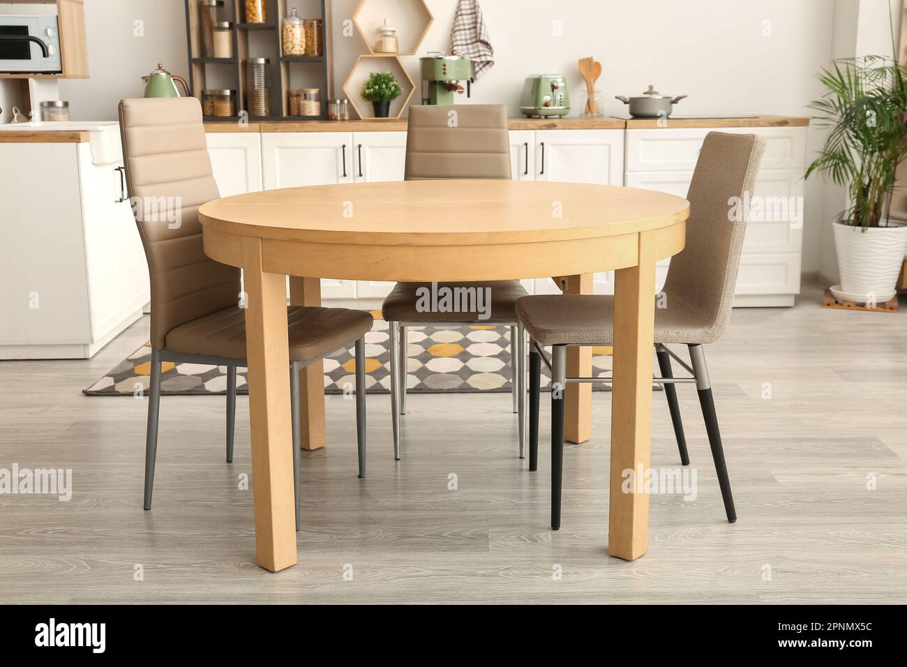 Clean dining table and chairs in interior of kitchen Stock Photo - Alamy