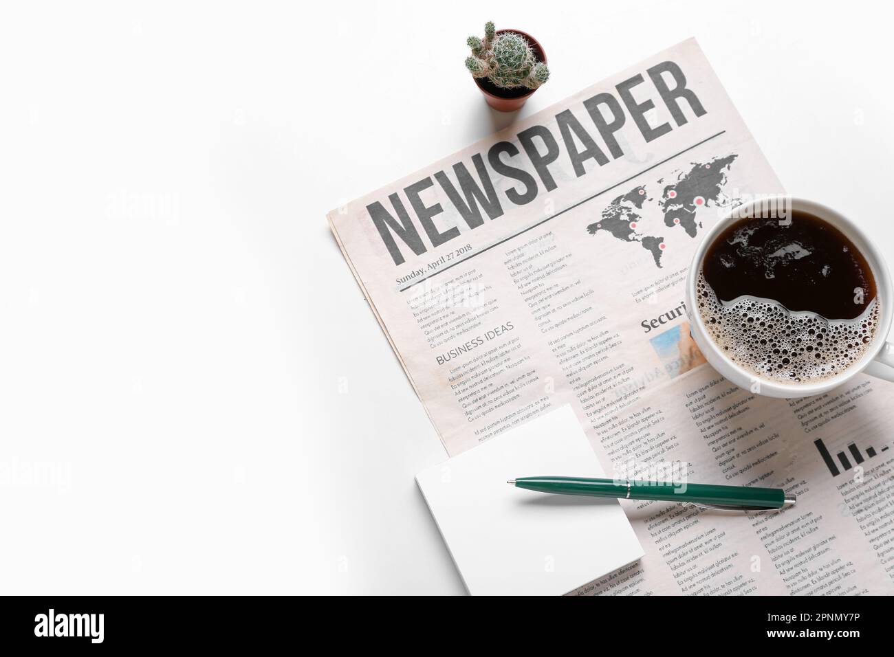 Newspaper with cup of coffee, sticky notes, pen and cactus on white ...