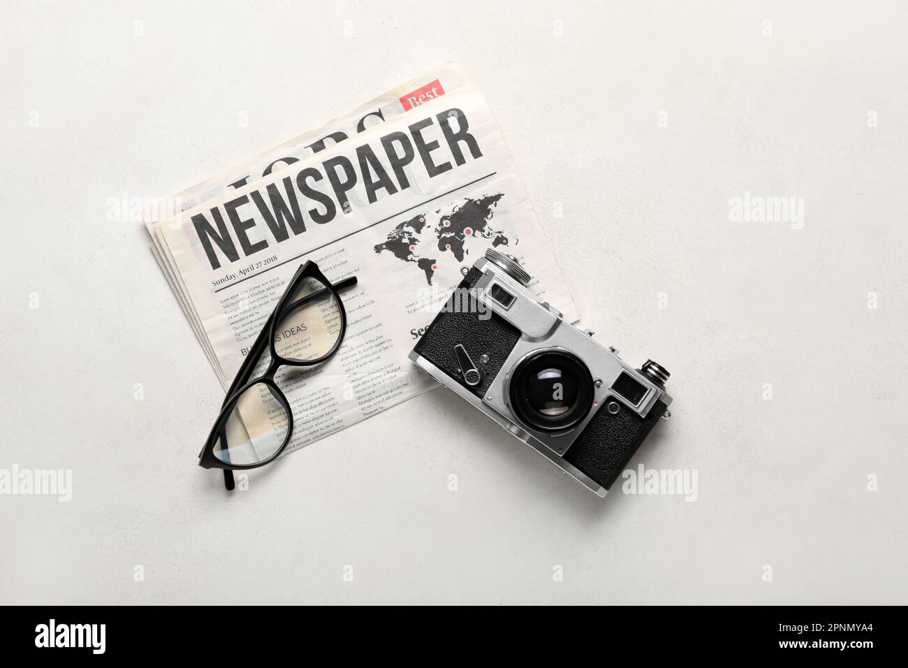 Newspaper with eyeglasses and photo camera on white background Stock ...