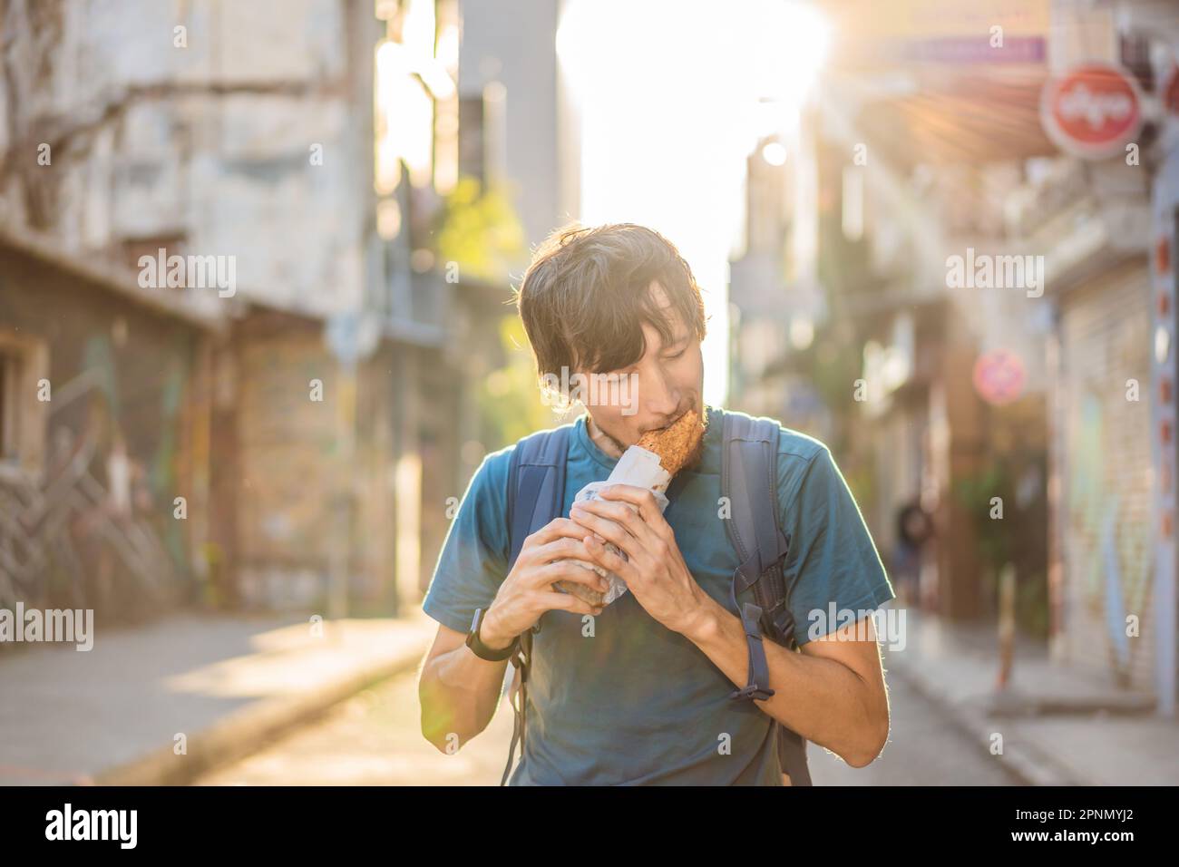 Man eating street food in Istanbul. Balik ekmek - fish in a bread ...