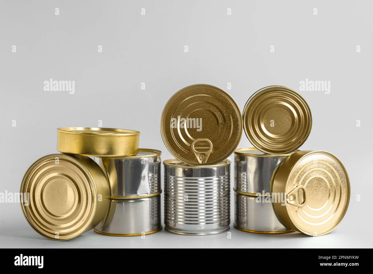 Different tin cans with fish on white background Stock Photo - Alamy