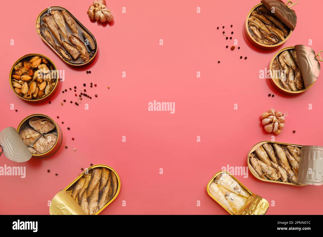 Frame made of tin cans with different fish and mussels on red ...