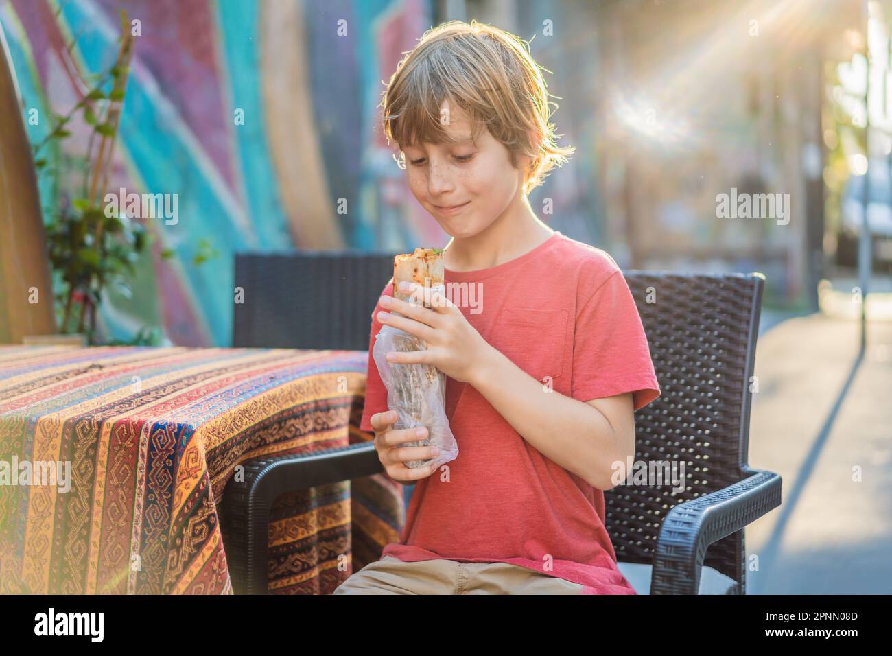 Boy eating street food in Istanbul. Balik ekmek - fish in a bread ...