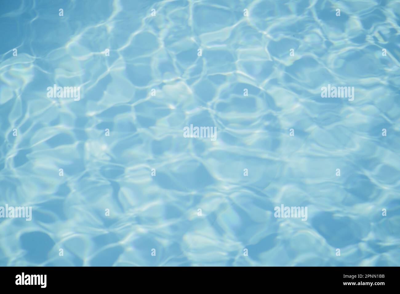 Blue pool water with sun reflections background Stock Photo - Alamy