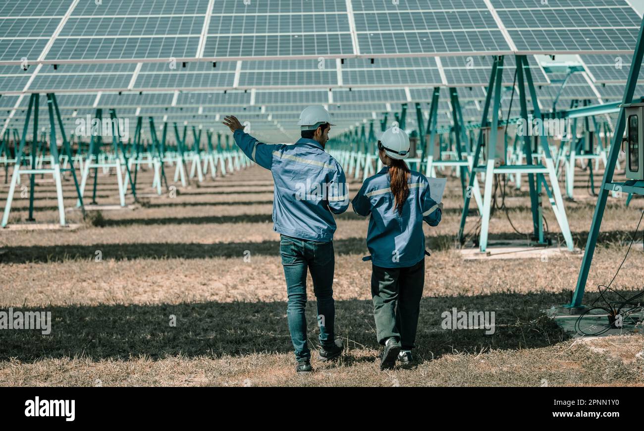 Solar design engineers visually inspect photovoltaic array installation ...