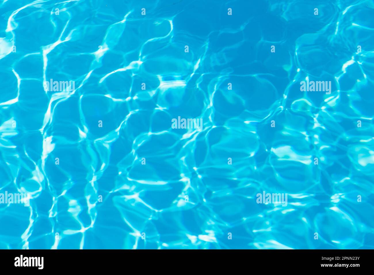Blue pool water with sun reflections background Stock Photo - Alamy
