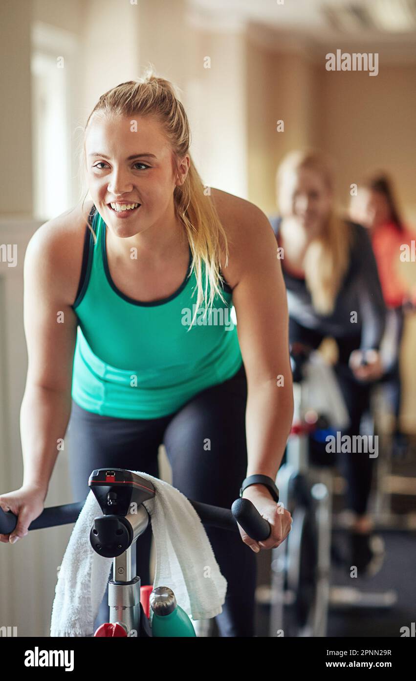 Feeling the effects of an awesome spin class. a young woman working out ...