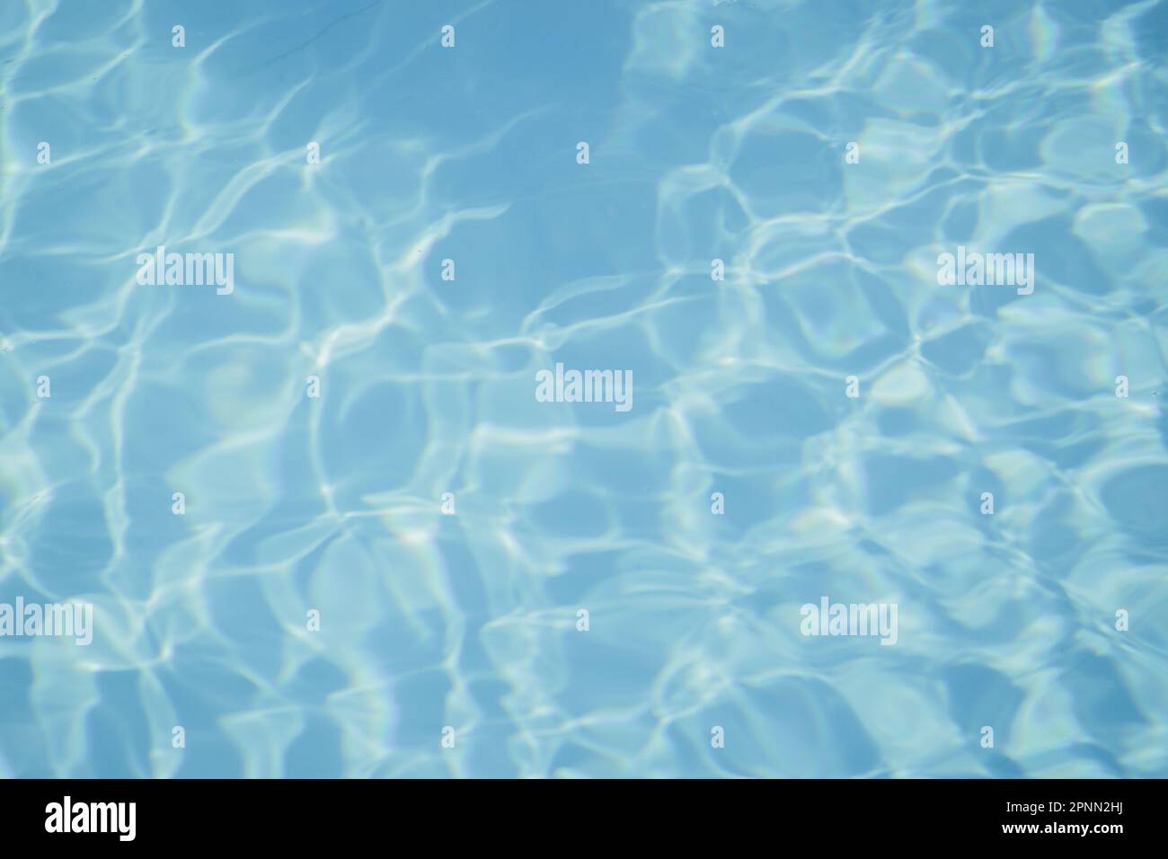 Blue pool water with sun reflections background Stock Photo - Alamy