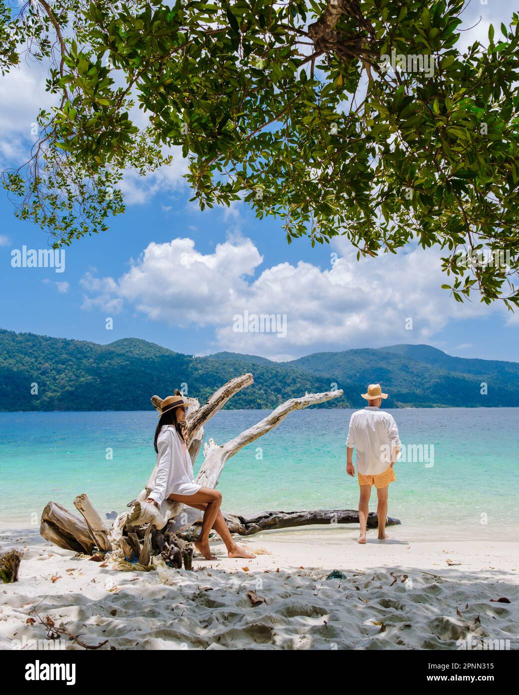 a men and women relaxing on the beach of Koh Lipe Island Southern ...