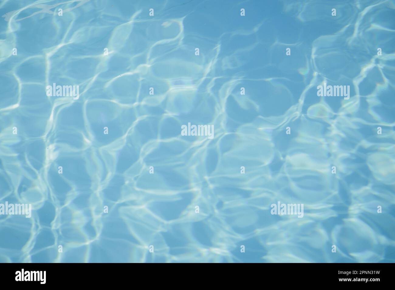 Blue pool water with sun reflections background Stock Photo - Alamy