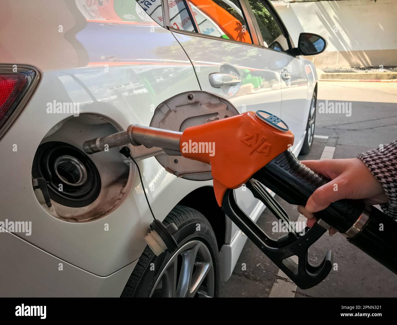Woman refueling car at the gas station background Stock Photo - Alamy