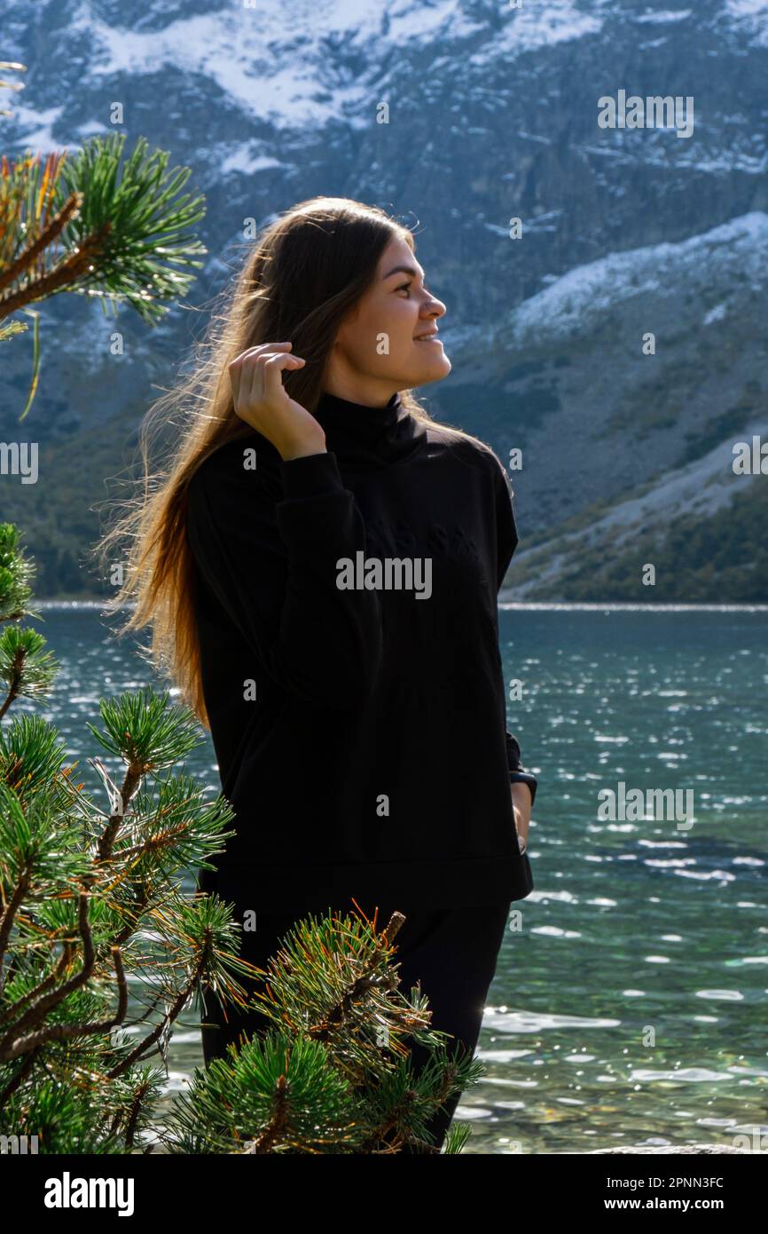 Young woman enjoying nature in Morskie Oko Snowy Mountain Hut in Polish ...