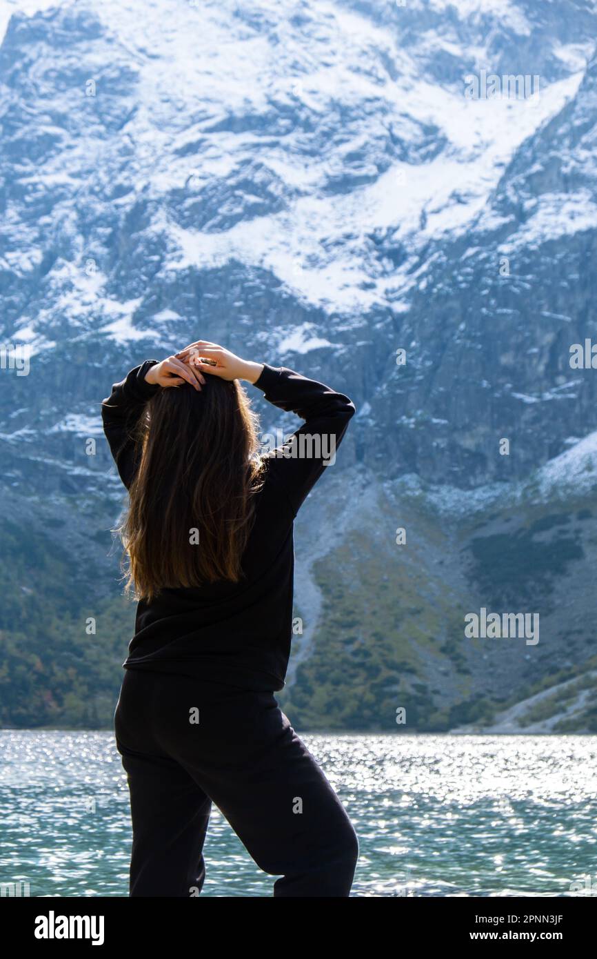 Young woman enjoying nature in Morskie Oko Snowy Mountain Hut in Polish ...