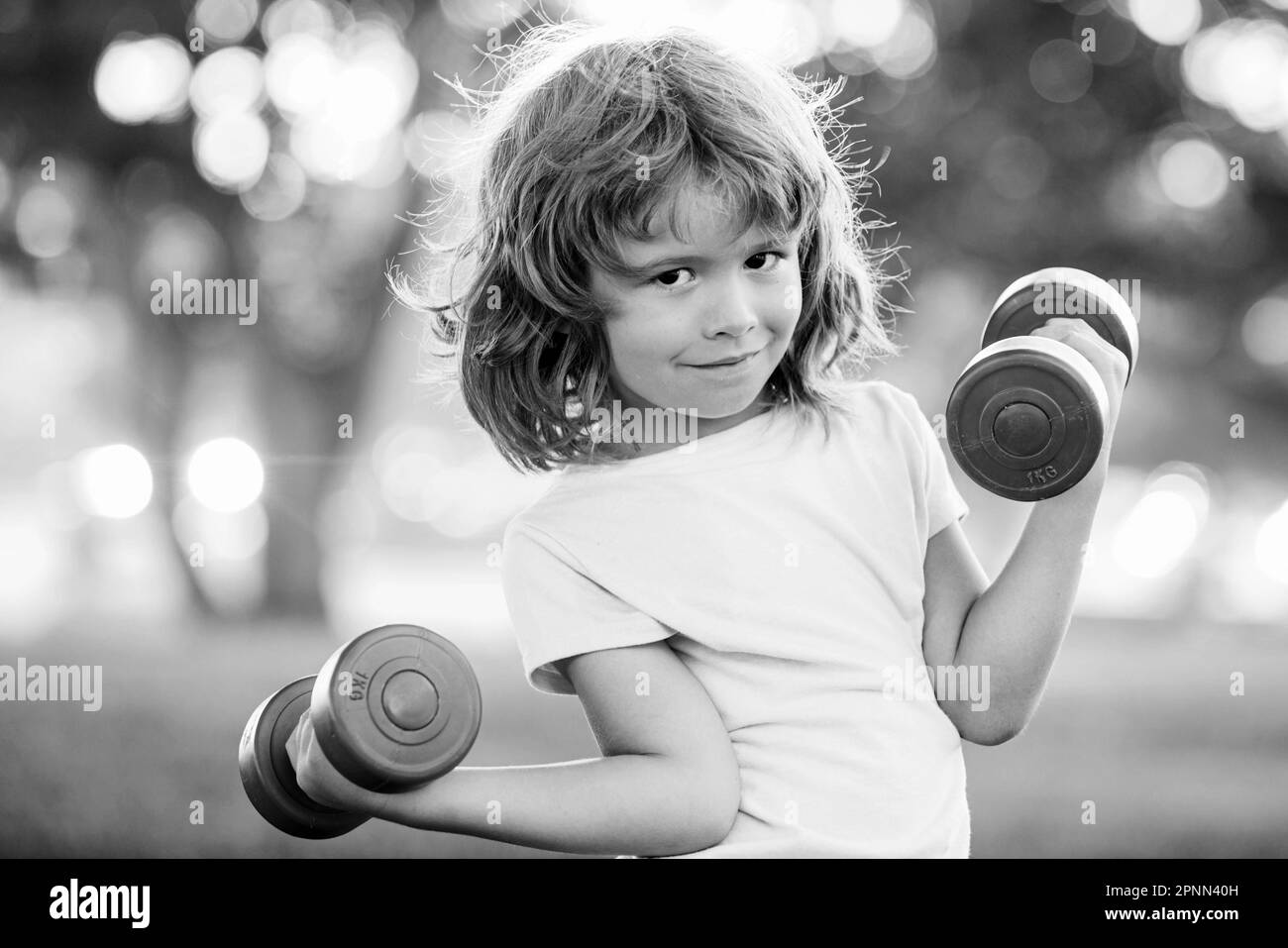 Sporty cute child with dumbbells. Kids sport and fitness, health and ...