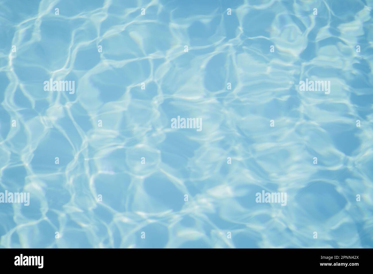 Blue pool water with sun reflections background Stock Photo - Alamy
