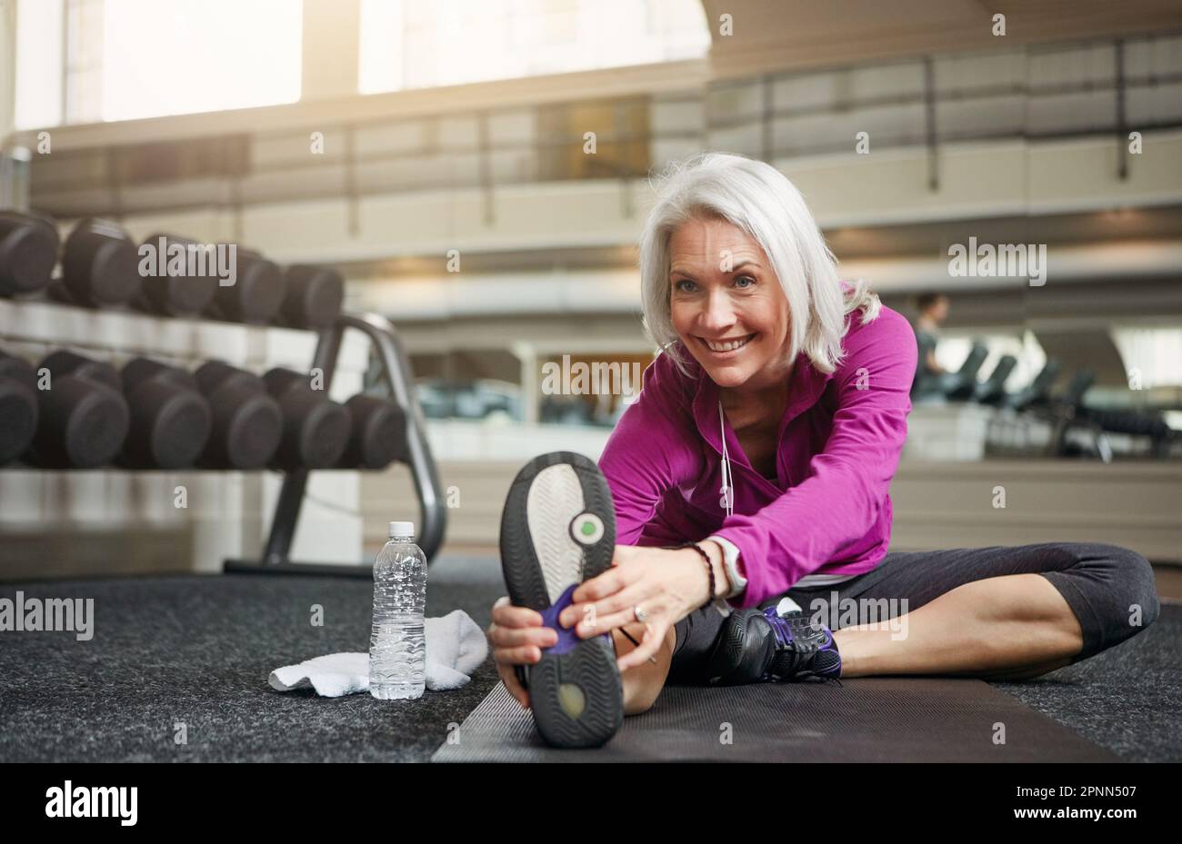 Fitness Fanatic In Her Fifties A Mature Woman Working Out At The Gym