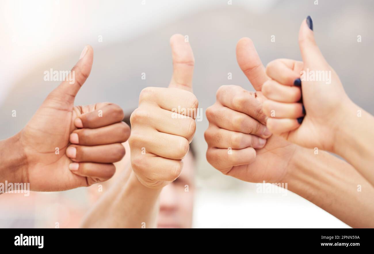 Closeup of people, hands and thumbs up for teamwork, collaboration and ...