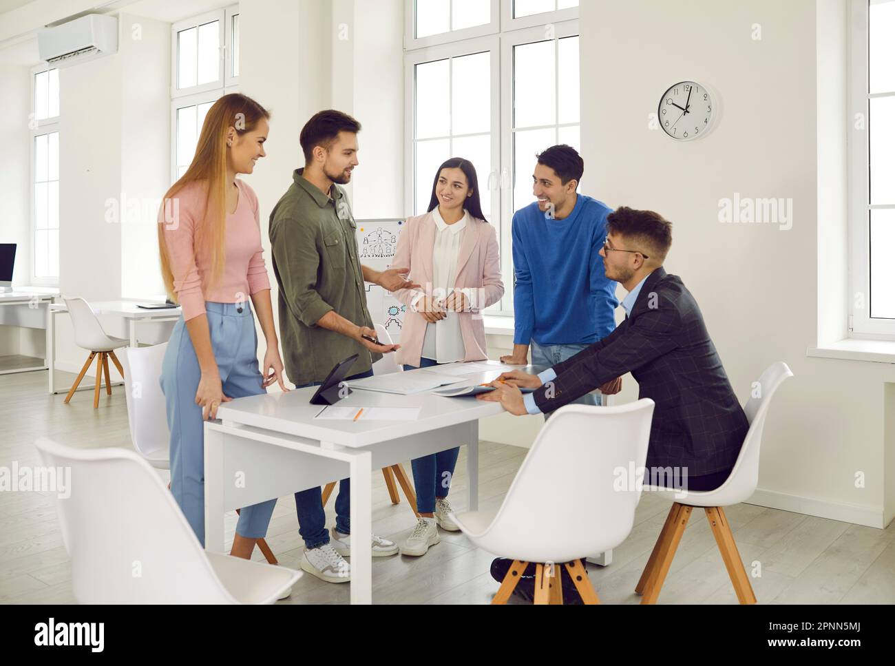 Diverse employees work together on project in office Stock Photo - Alamy