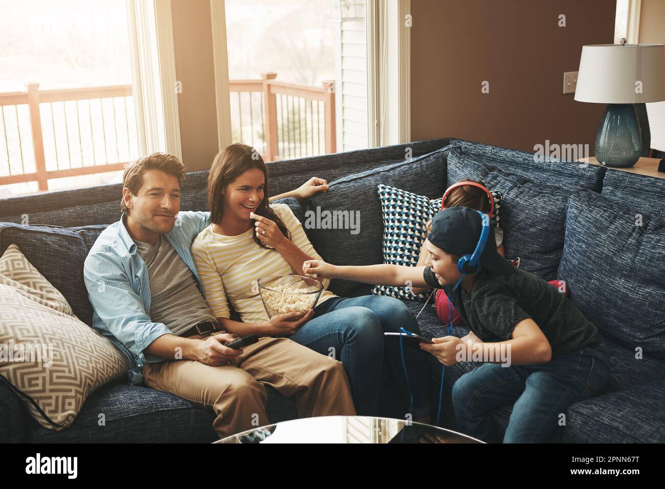 Plugged in to a leisurely weekend. a couple watching tv while their ...