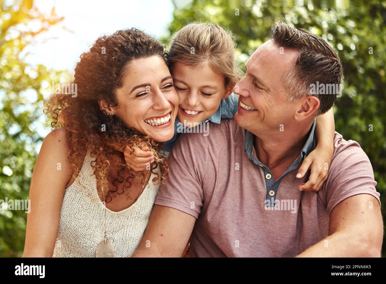 Love is what makes a family. a family of three enjoying a day outdoors ...