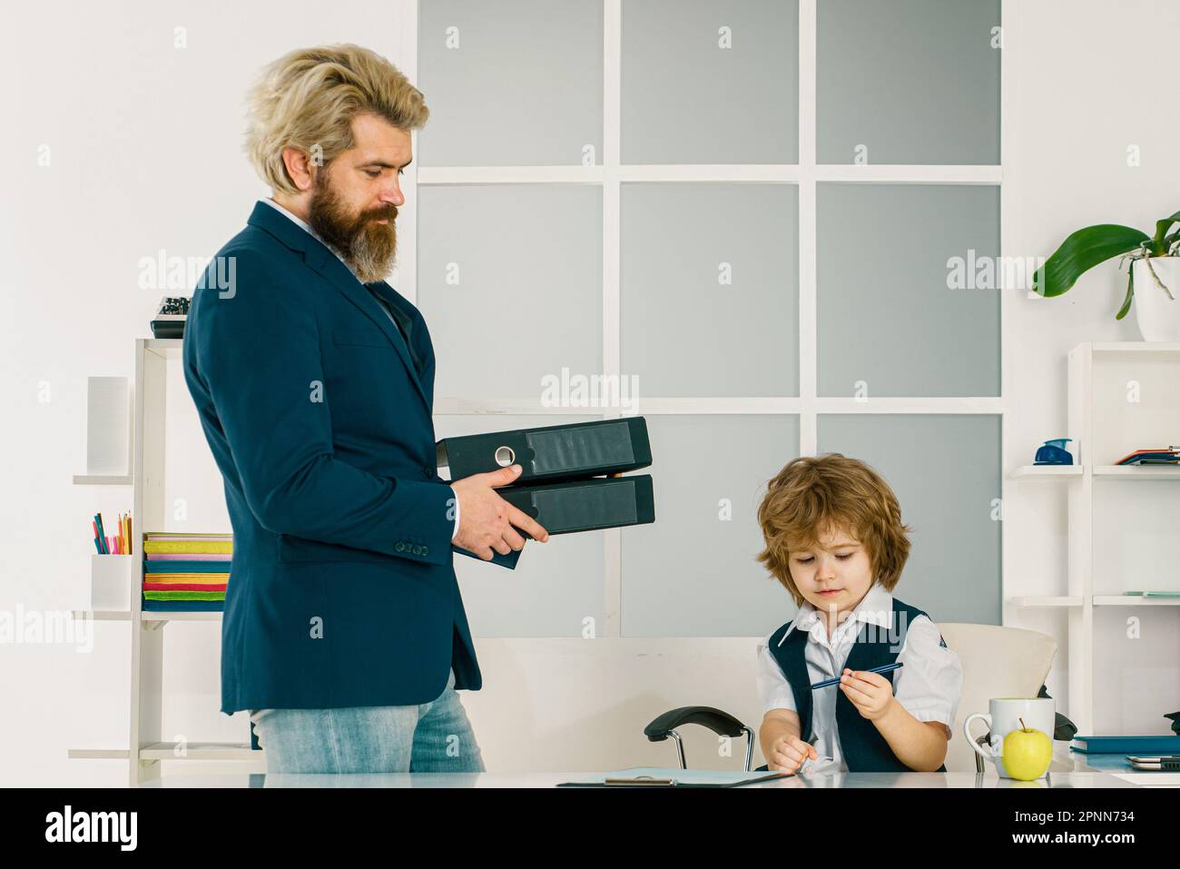 Little boss in office. Son helping father working in office. Office ...
