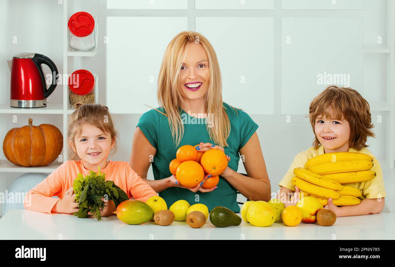 Healthy fruit for kids. Happy children and mother with fruits in ...