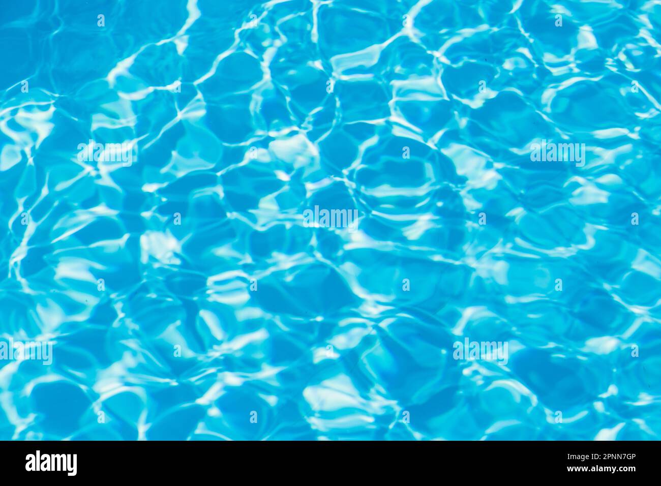 Blue pool water with sun reflections background Stock Photo - Alamy