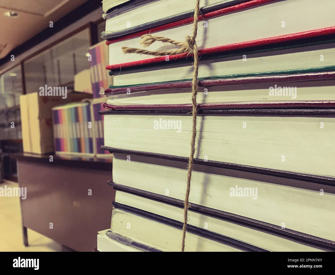 Pile of old books with rope background Stock Photo - Alamy