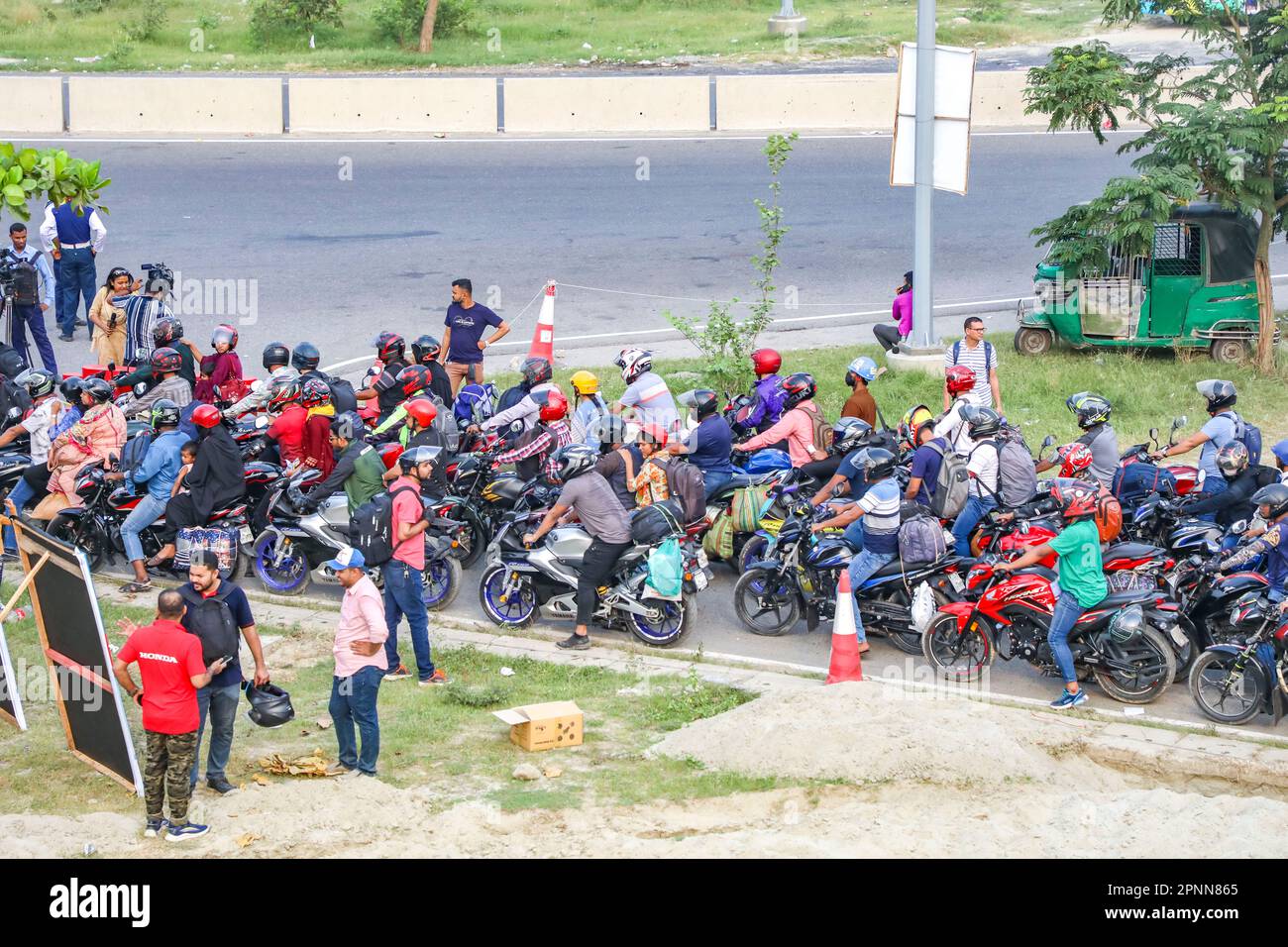 Dhaka, Bangladesh. 20th Apr, 2023. People on motorcycles queue to pay ...