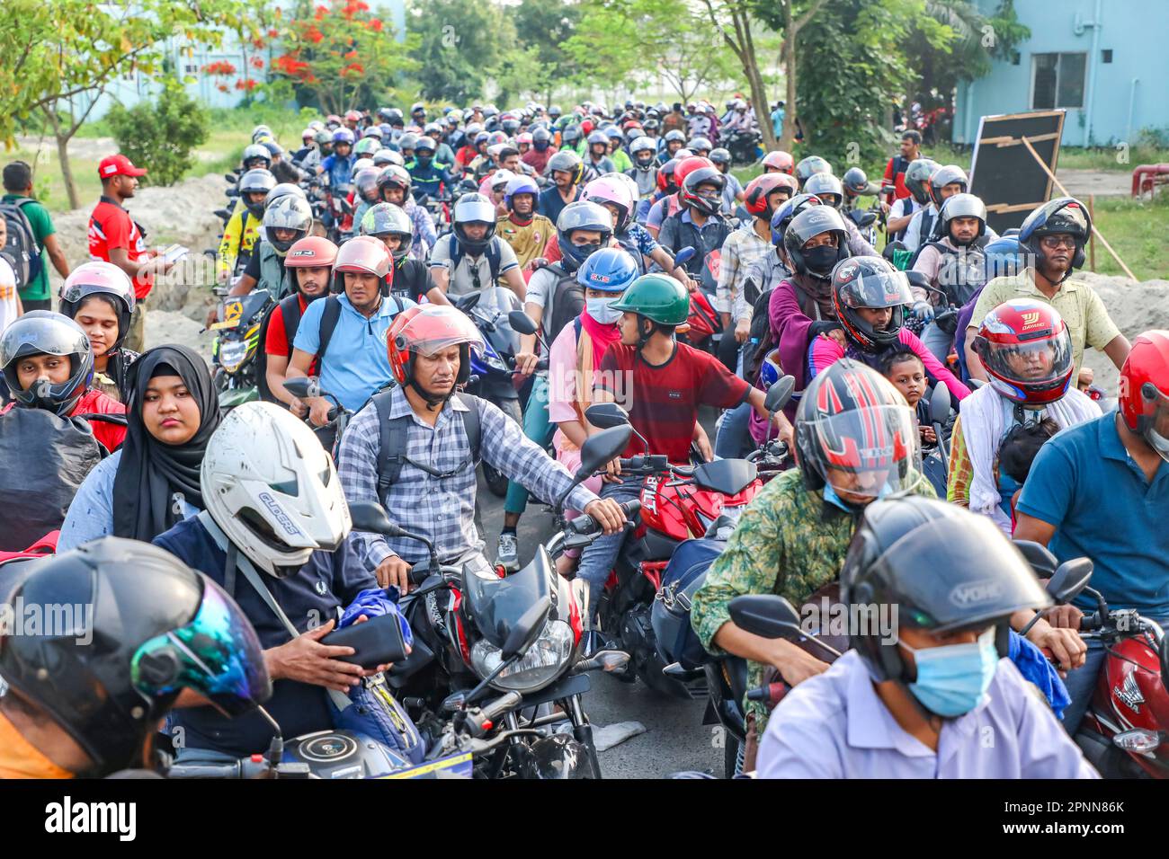 Dhaka, Bangladesh. 20th Apr, 2023. People on motorcycles queue to pay ...