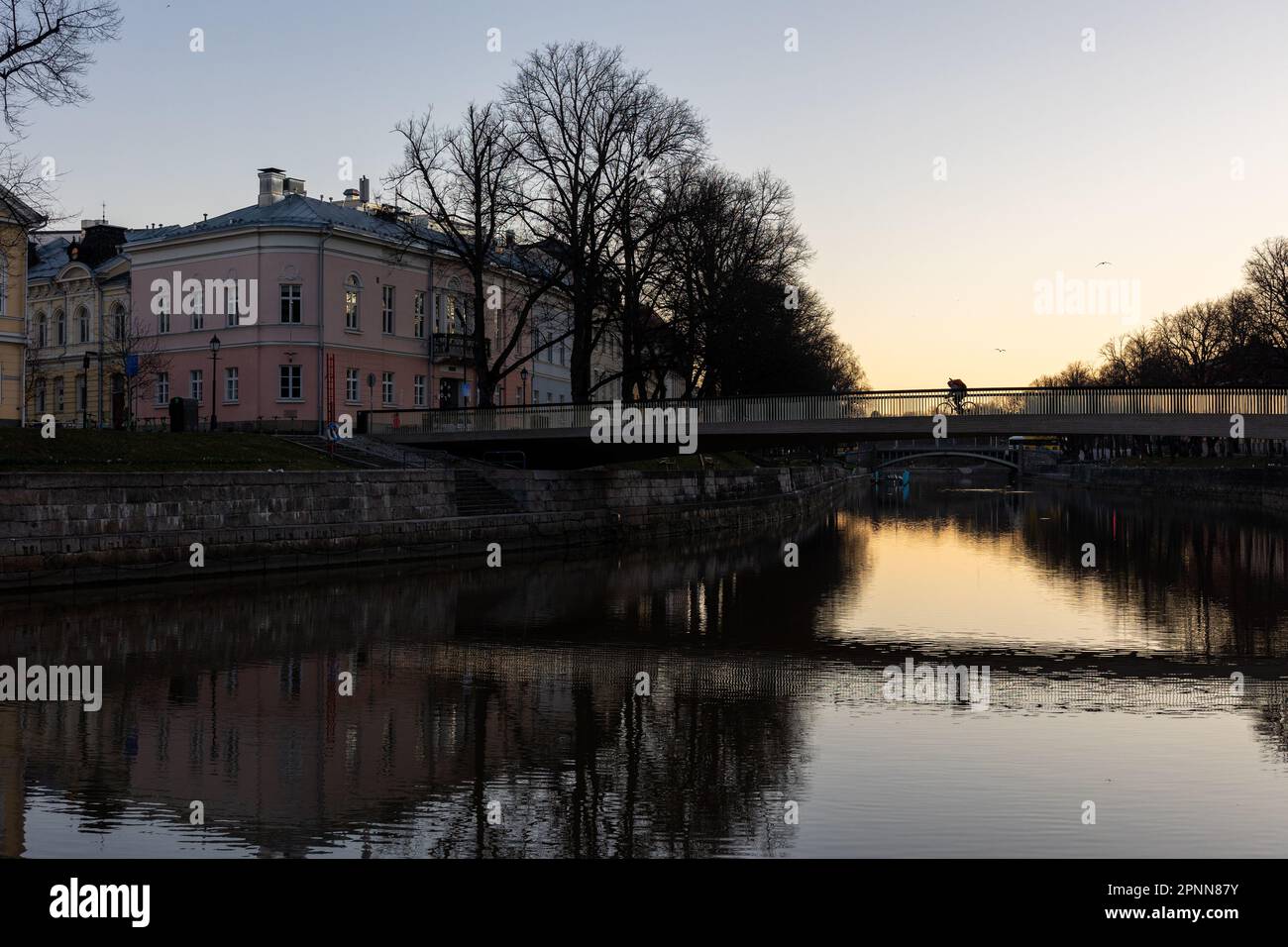 Person with bicycle on kirjastosilta bridge in spring in Turku, Finland ...