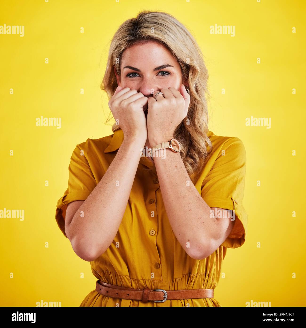 Portrait, shy and woman with fist on face in studio isolated on a ...
