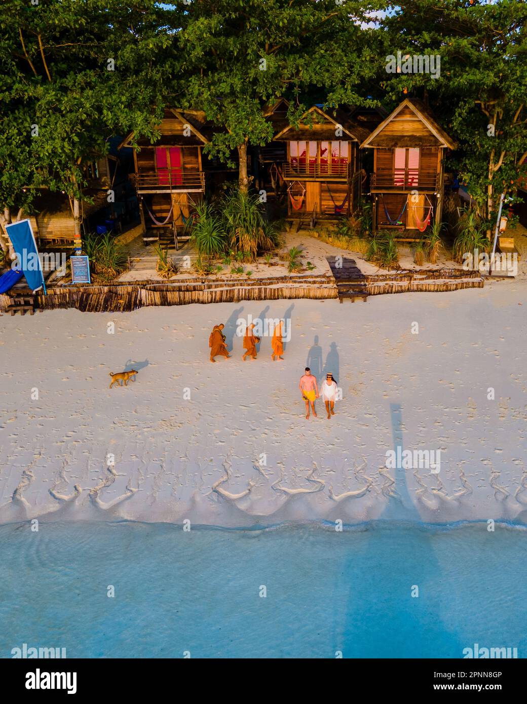 Couple of men and women on vacation at Koh Lipe Thailand walking on the ...